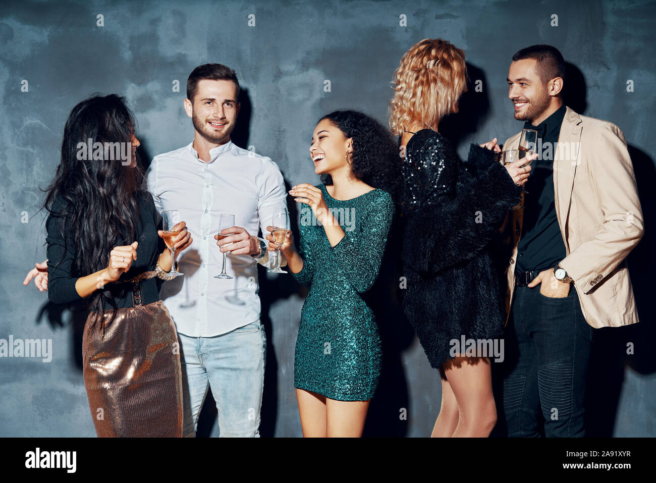 Diverse group of young people dancing in night club, enjoy party and ...