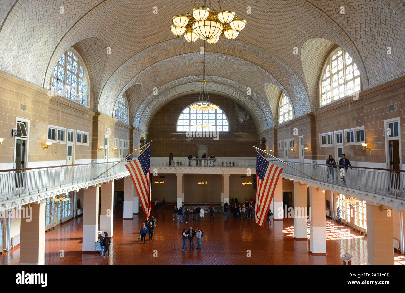 ELLIS ISLAND, NY - 04 NOV 2019: Tourists at the Great Hall inside the ...