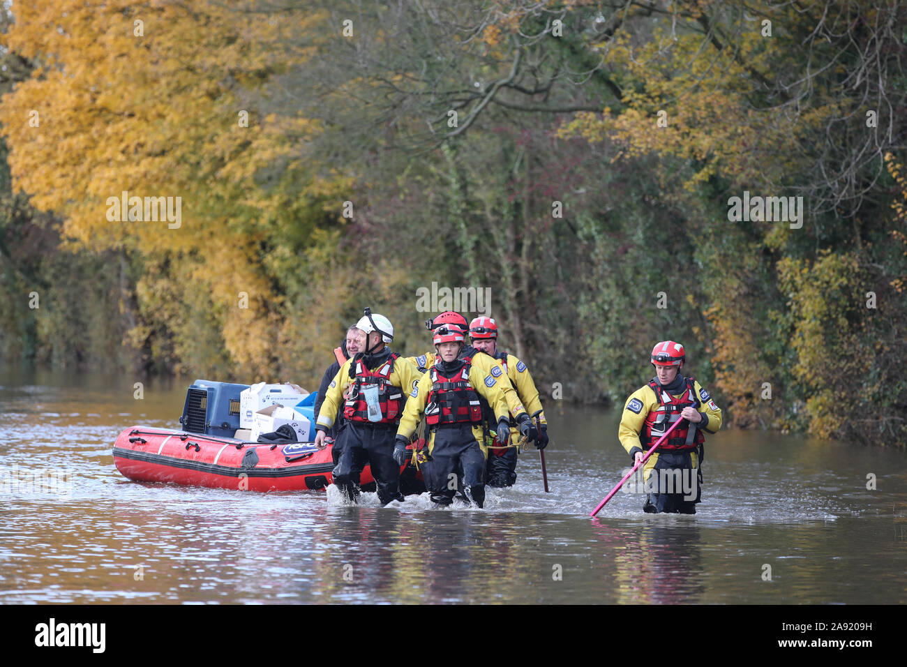 Rescuers pull a boat through floodwater in Fishlake, Doncaster. The ...
