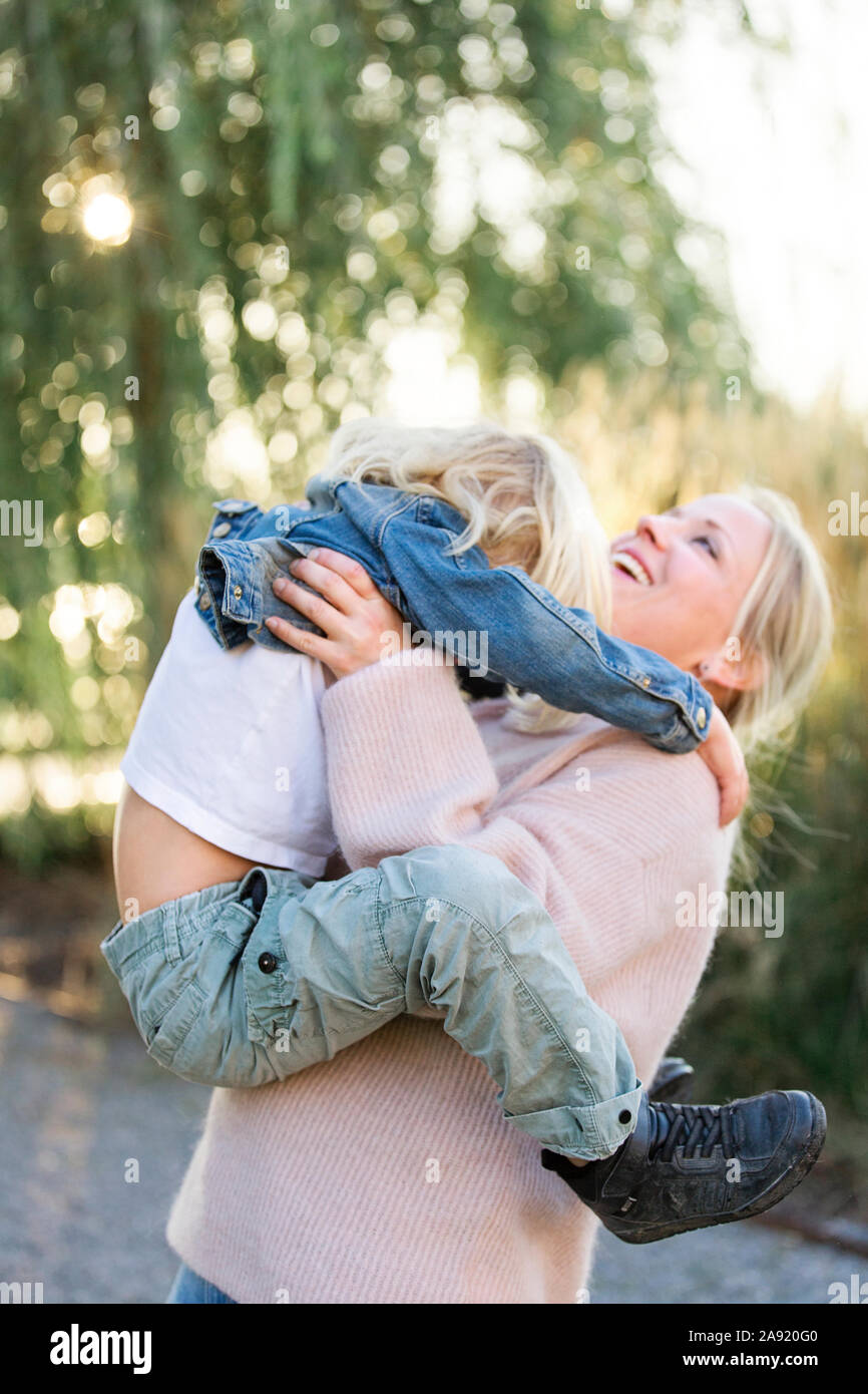 Mother hugging son Stock Photo - Alamy