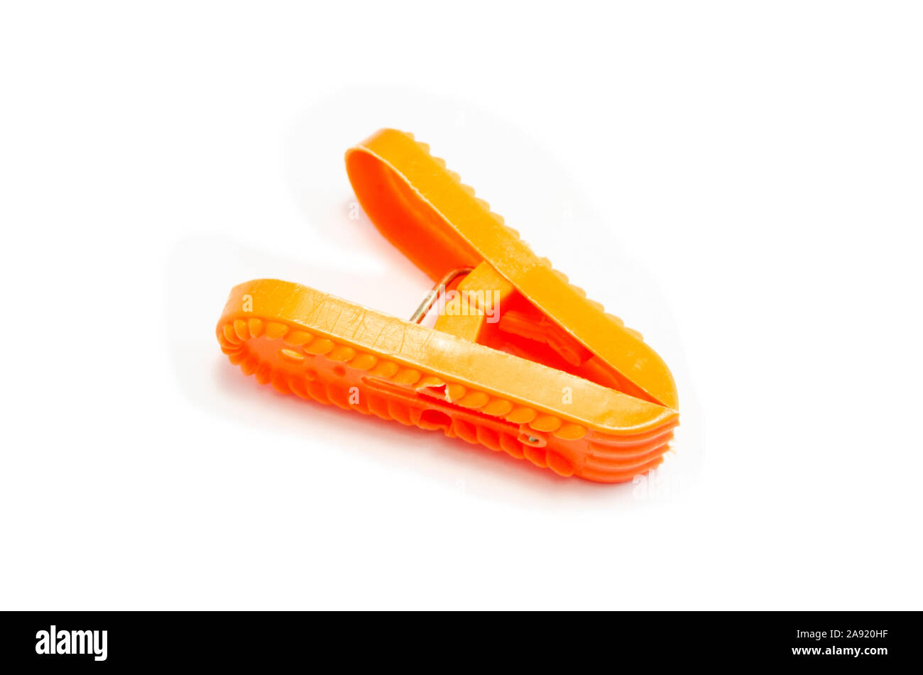 Single orange plastic clothespin cloth peg on white background Stock ...