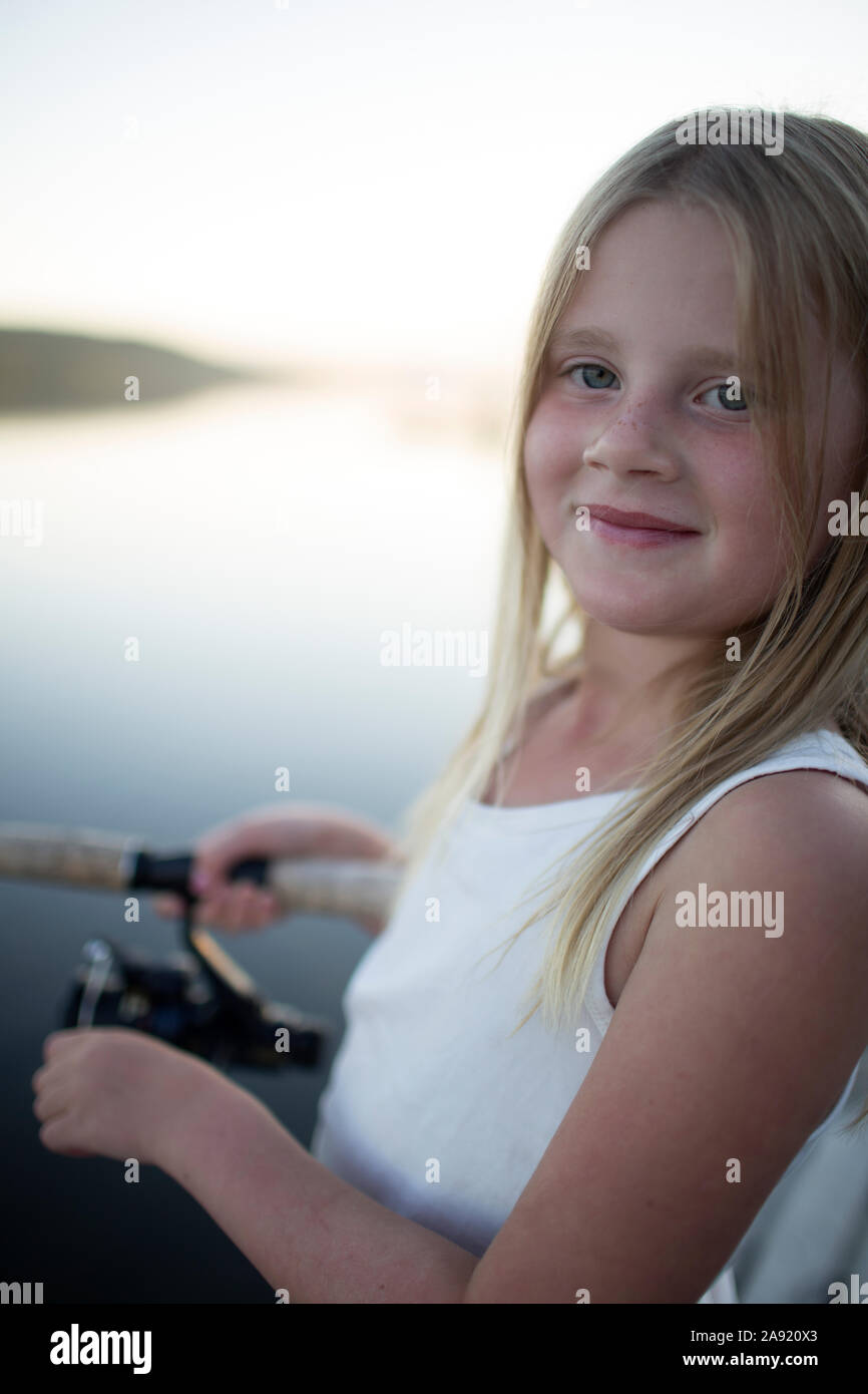 Girl fishing in lake Stock Photo - Alamy