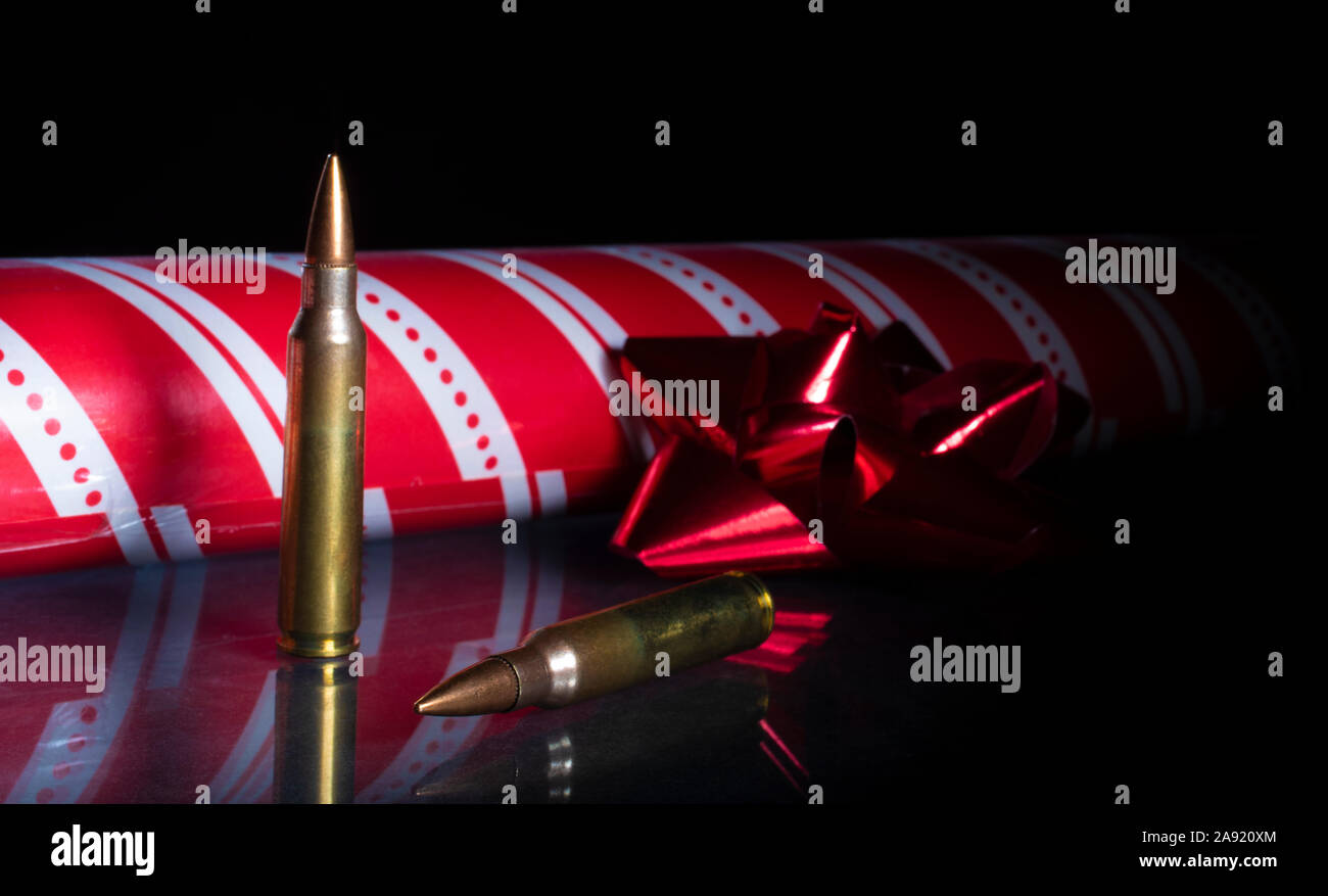 Rifle catridges with Christmas wrapping paper and a bow Stock Photo - Alamy