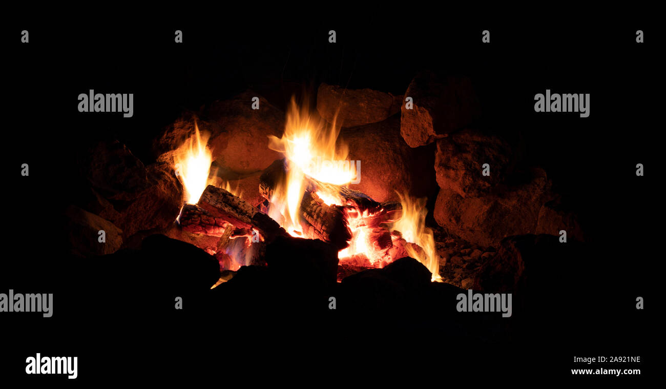 Fire surrounded by rocks at night in the outdoors Stock Photo - Alamy