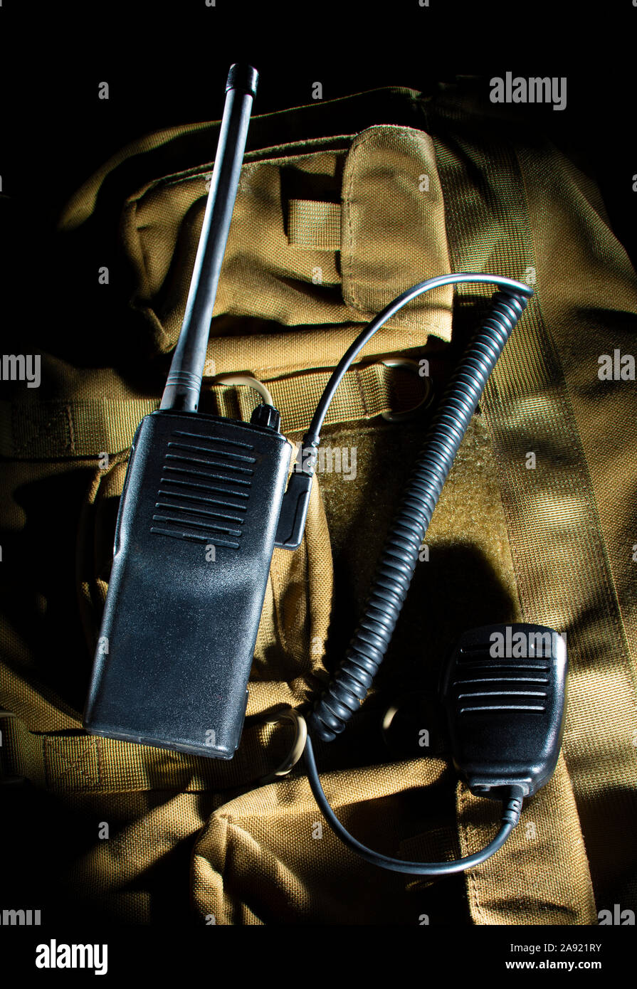Two way radio and microphone on a brown backpack Stock Photo - Alamy