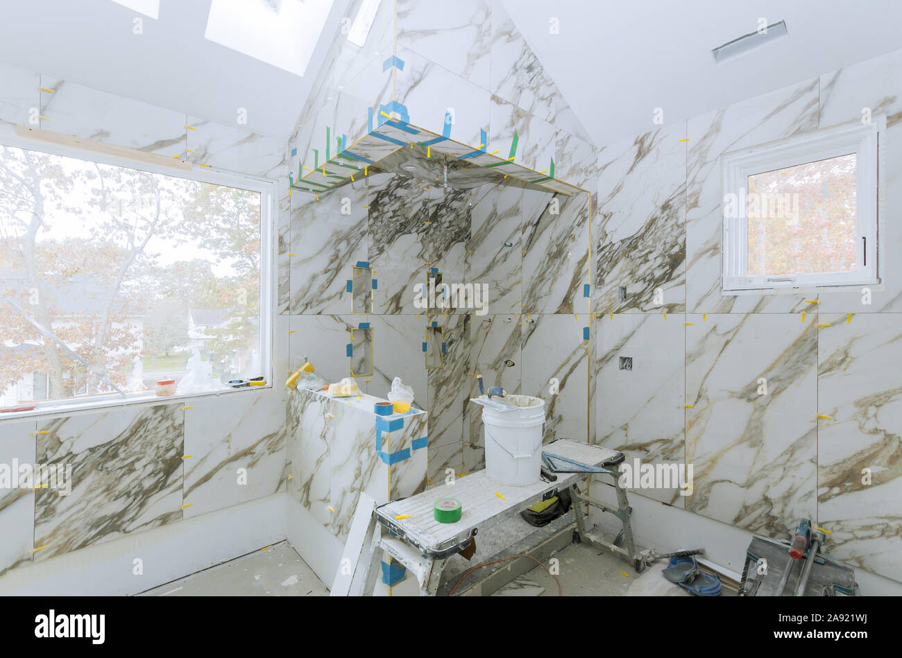 Construction work installing ceramic tile on reconstruction of bathroom ...
