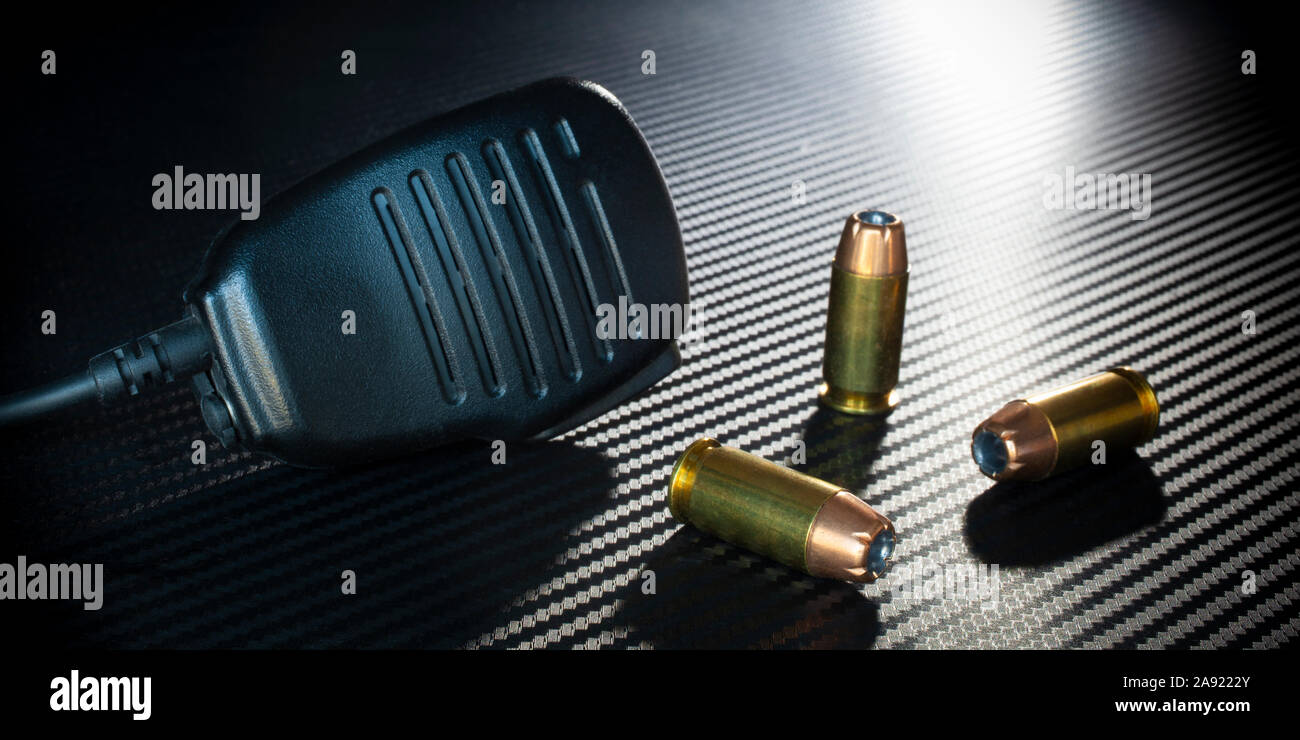 Microphone for a two way radio and ammunition for a handgun Stock Photo ...