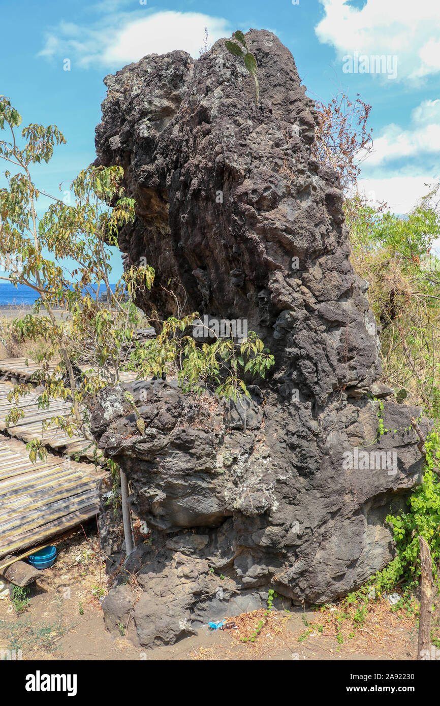 Black rock from solidified lava. Abstract shape of huge black stone ...