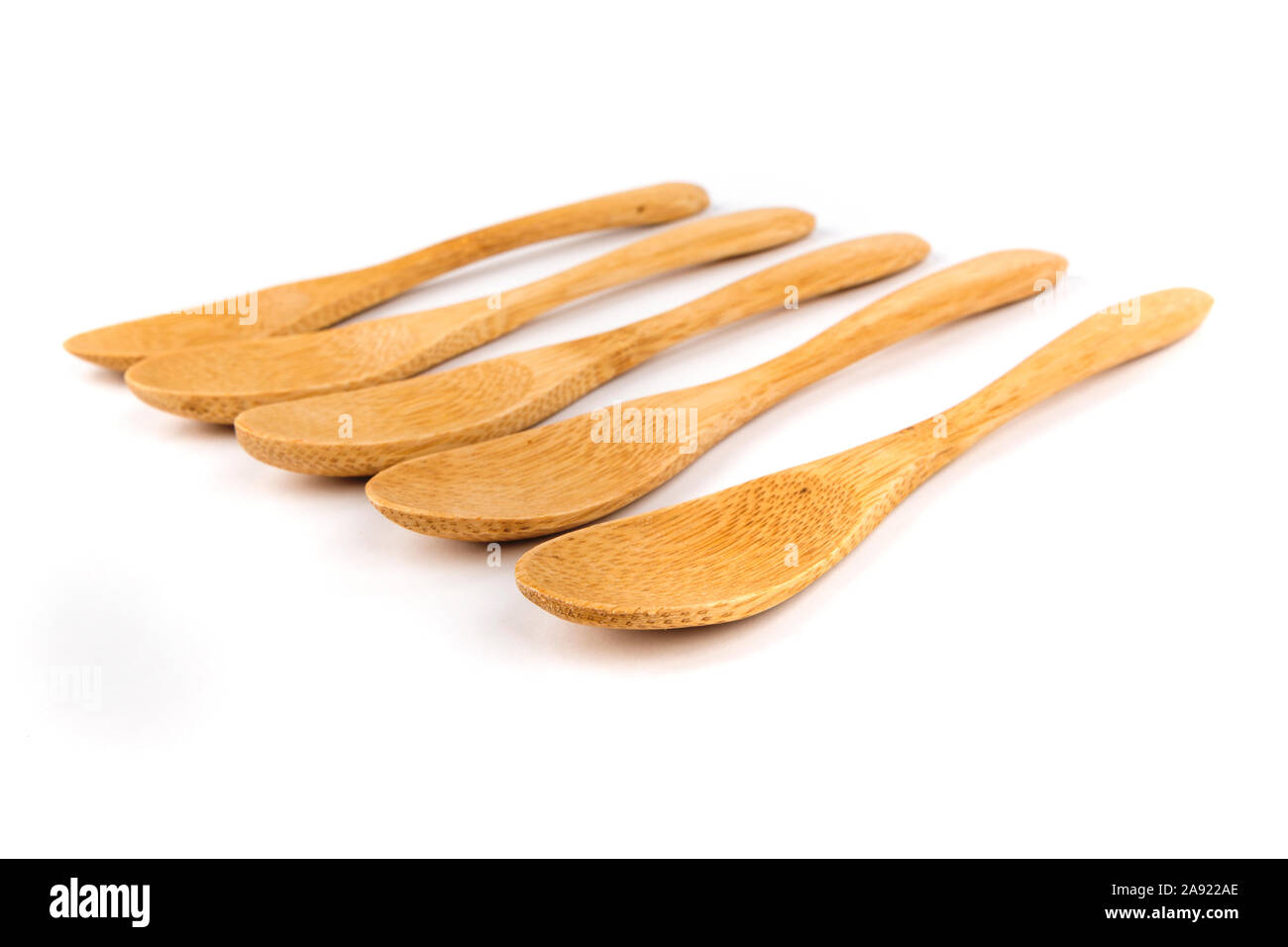 Five shallow bamboo spoons in a row Stock Photo - Alamy