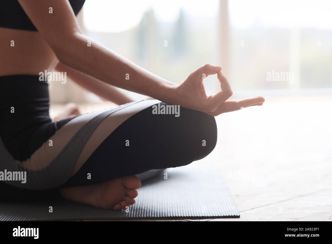 Leg and hand of yoga woman sitting in lotus pose Stock Photo - Alamy