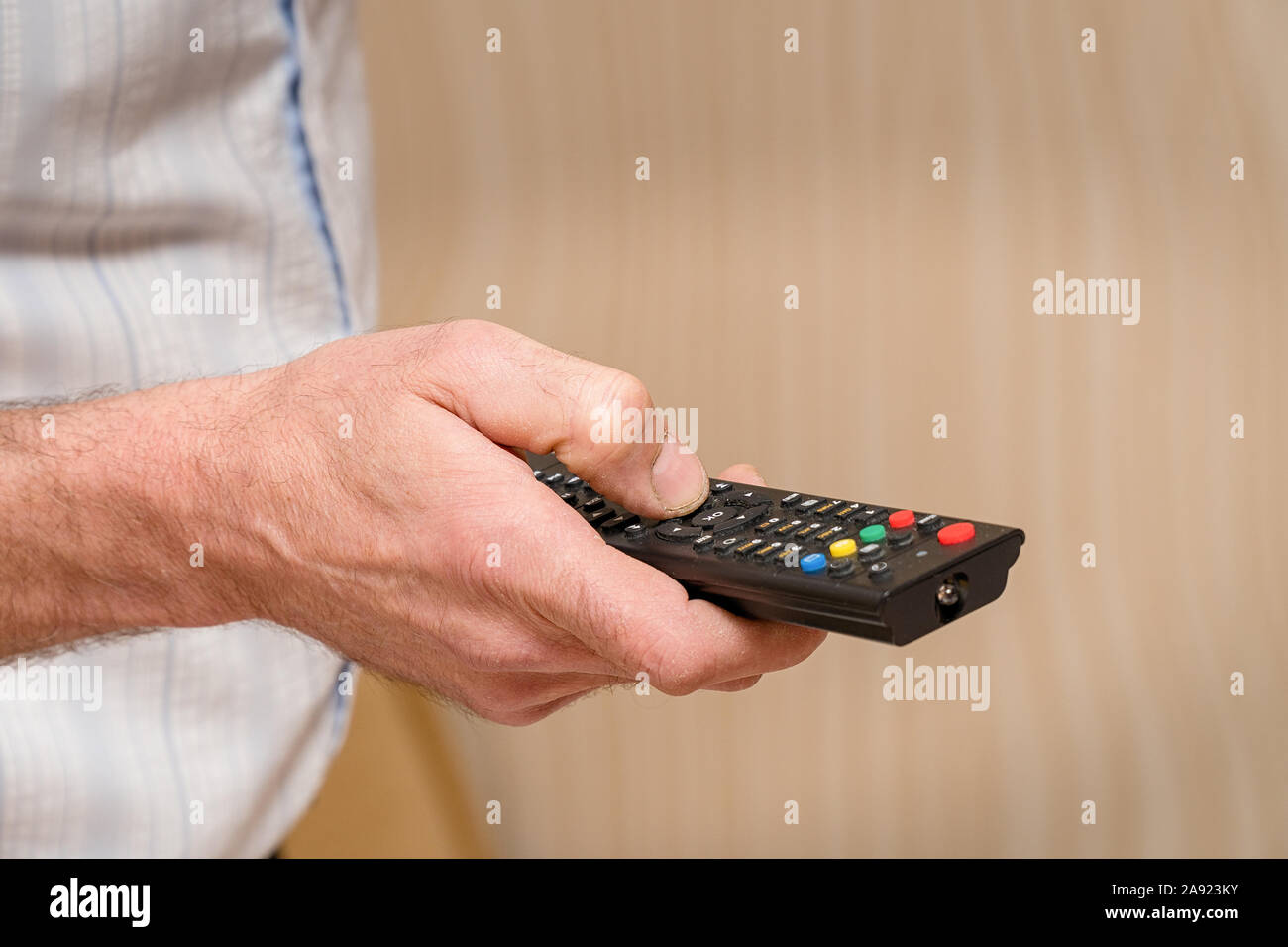 TV remote in the hand of a man Stock Photo - Alamy