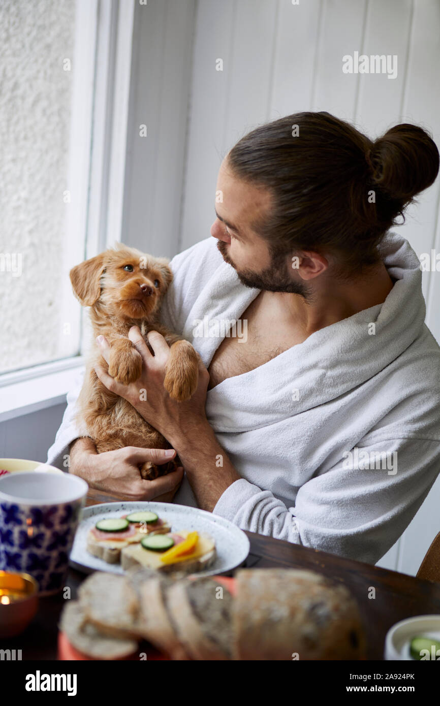 Man holding puppy Stock Photo - Alamy