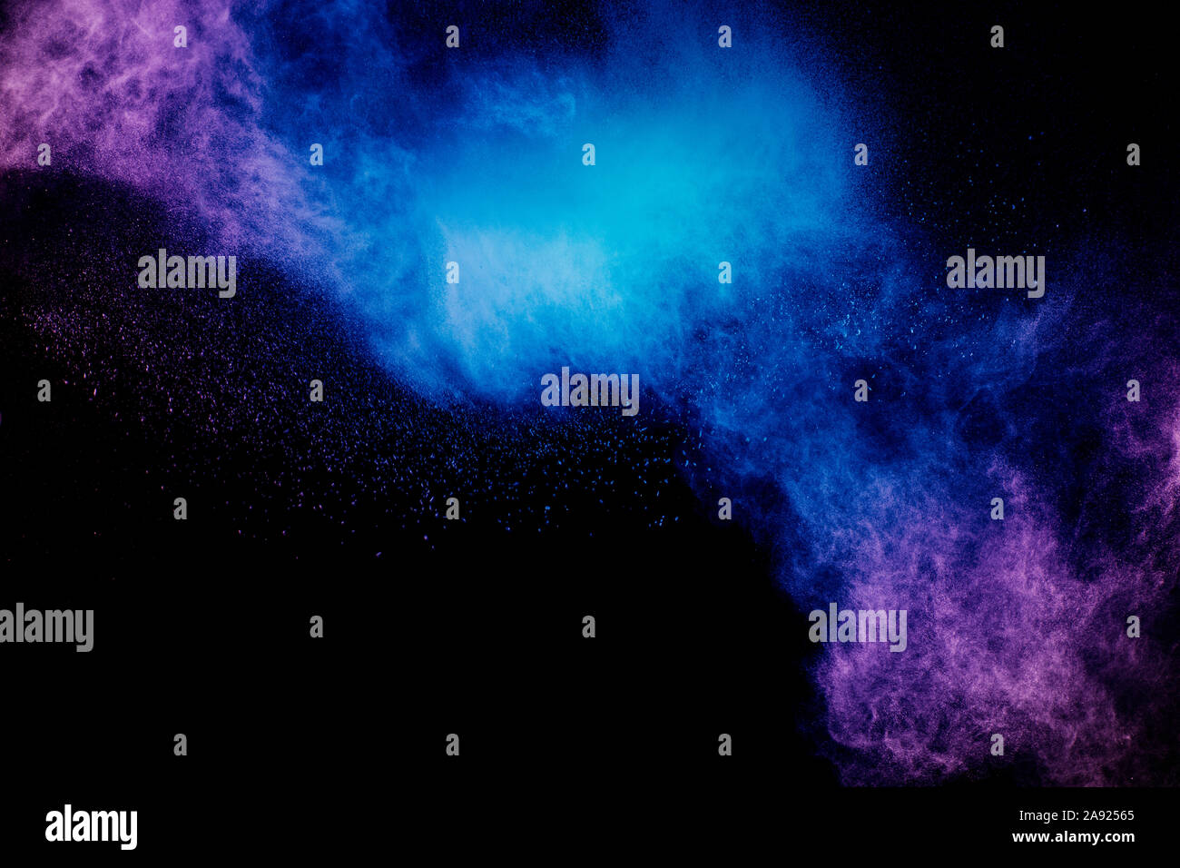 Explosion of pink blue colored powder isolated on black background.Pink ...