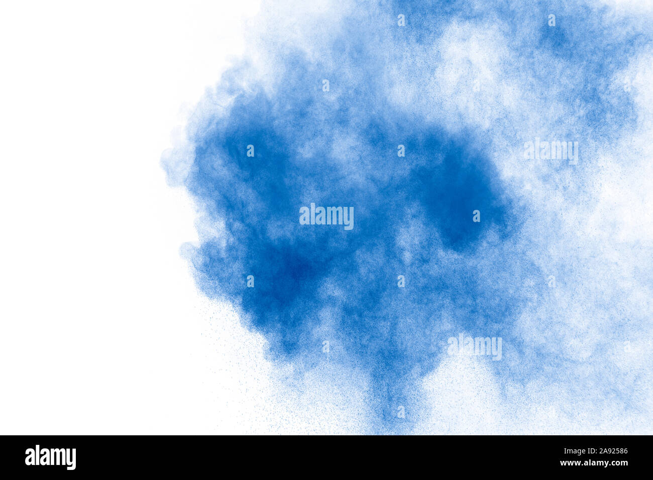 Abstract blue dust explosion on white background. Freeze motion of blue ...