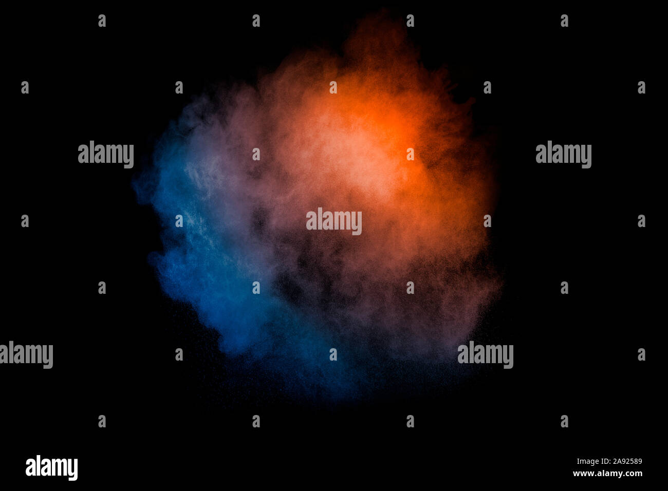Orange blue powder explosion on black background.Orange blue color dust ...