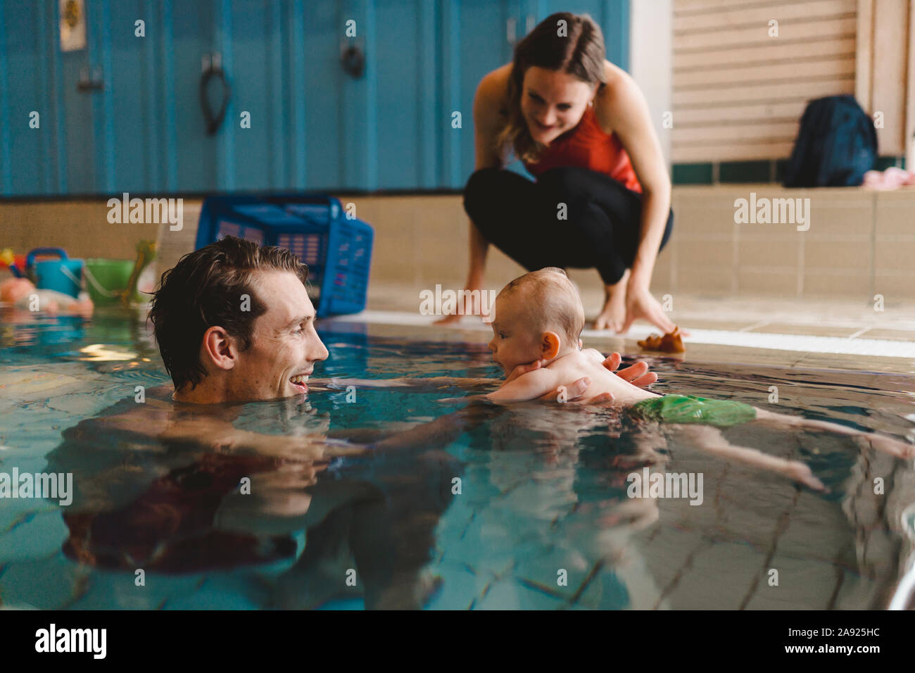 Father with baby in swimming-pool Stock Photo - Alamy