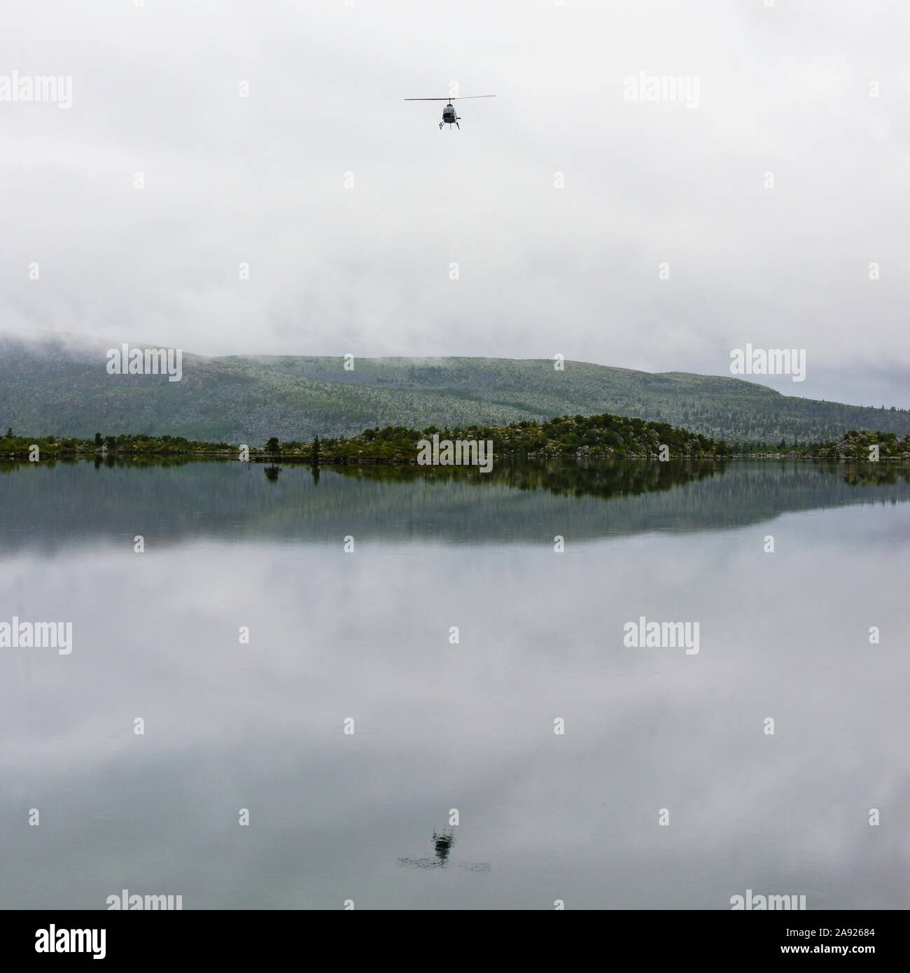 Reflection flying helicopter in water hi-res stock photography and ...