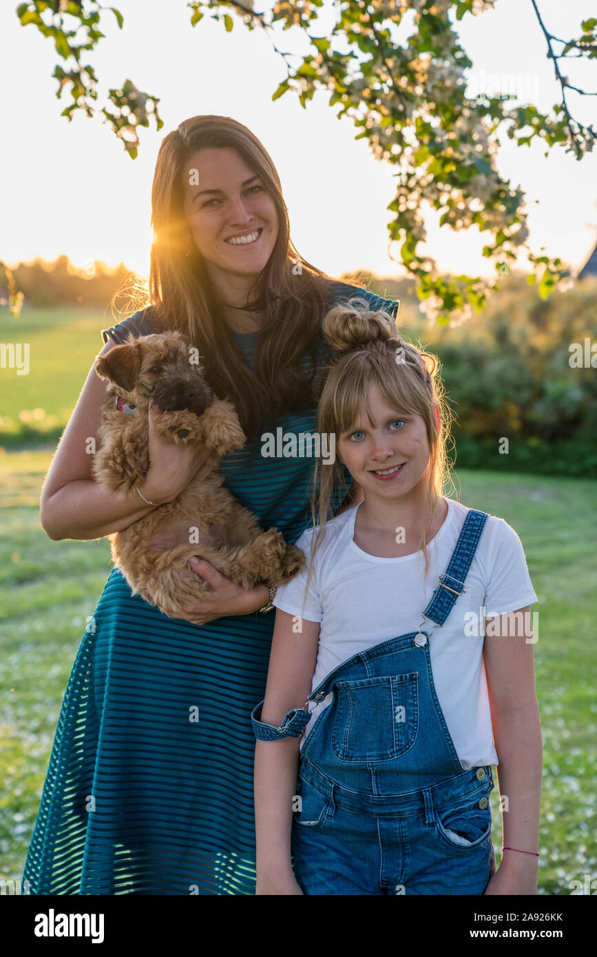 Sisters with dog Stock Photo - Alamy