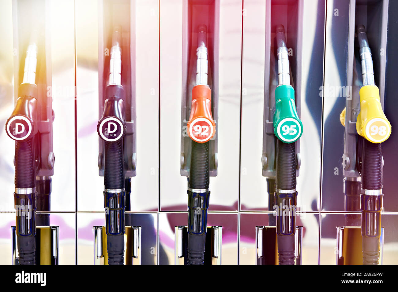 Fuel nozzles on filling station closeup Stock Photo - Alamy
