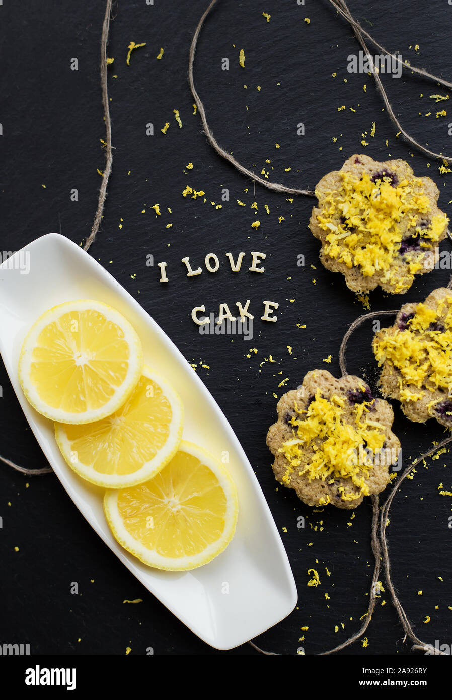 lemon cupcakes on a black background with lemon zest, inscription I ...