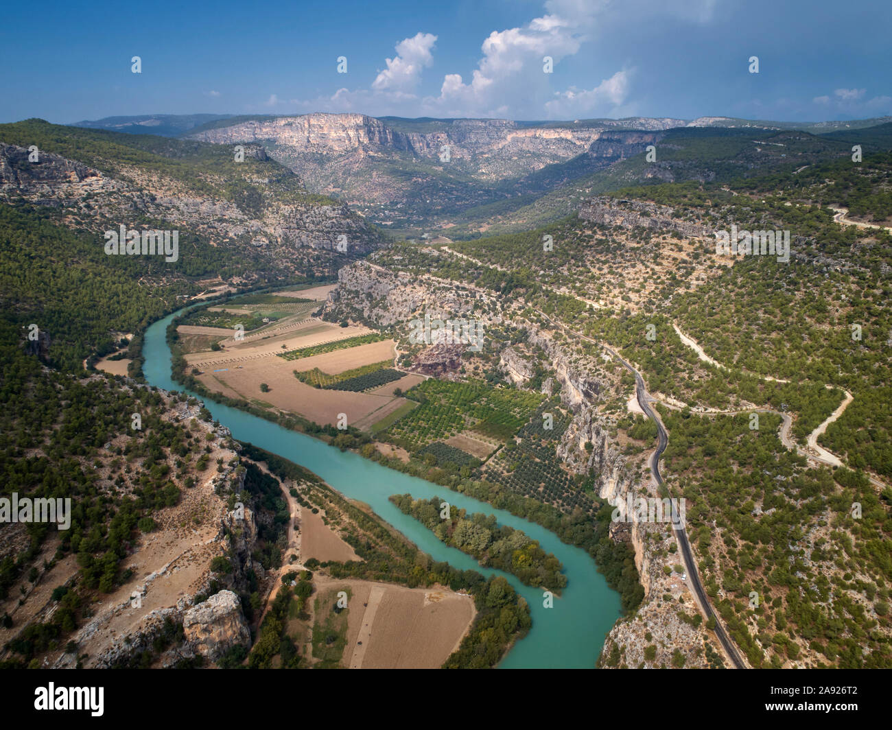 Mountain landscape with river, island, roads and clouds at the horizon ...
