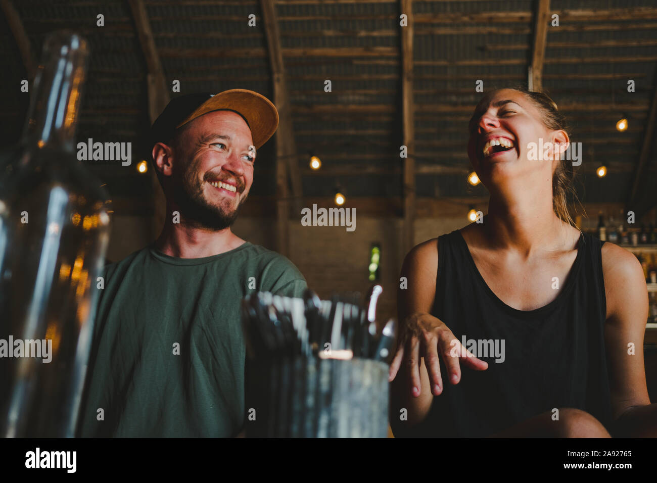Happy friends in bar Stock Photo - Alamy