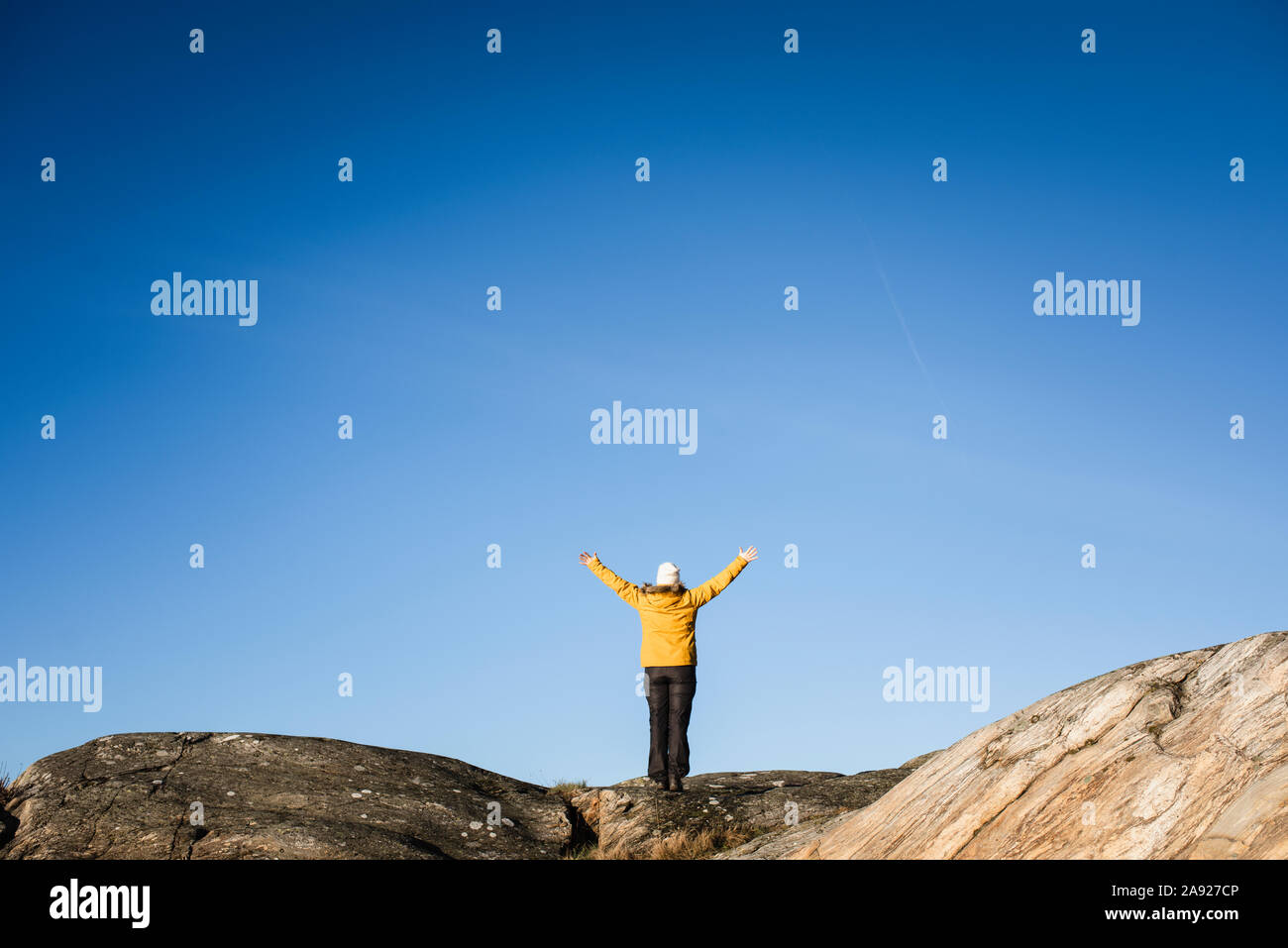 Woman standing on rocks Stock Photo - Alamy
