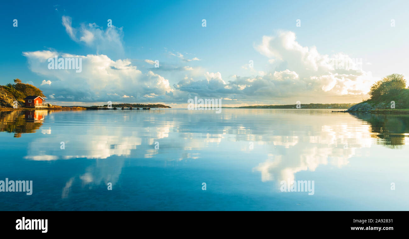 Clouds reflecting in sea Stock Photo - Alamy