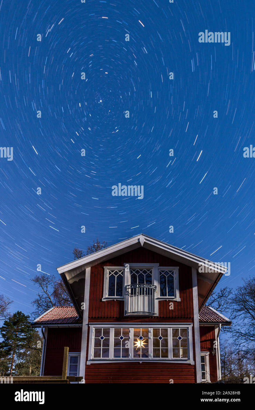 Wooden house at dusk Stock Photo - Alamy
