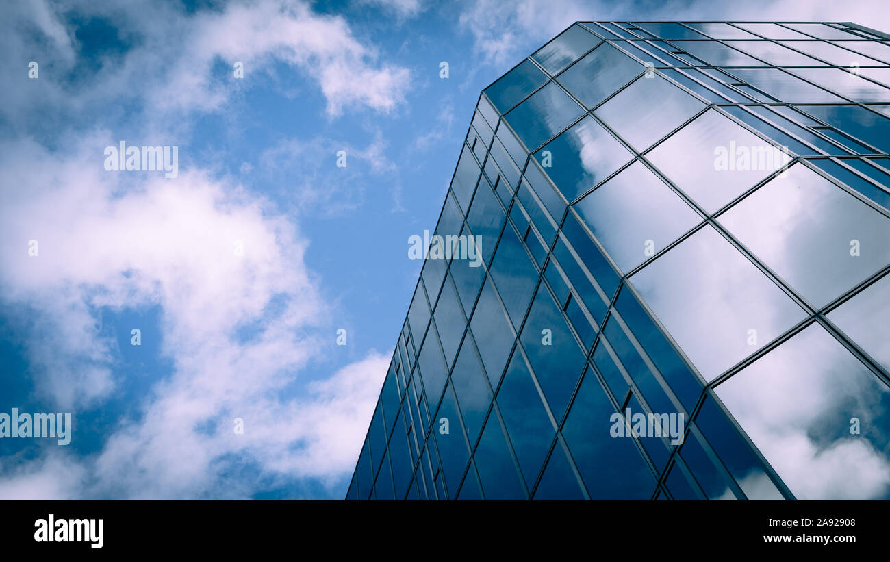 Futuristic Business. Low angle view of a glass and steel skyscraper ...