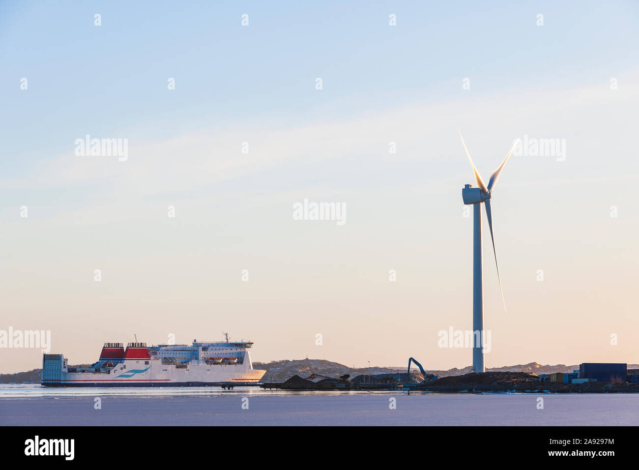 Cargo ship on sea, wind turbine on background Stock Photo - Alamy