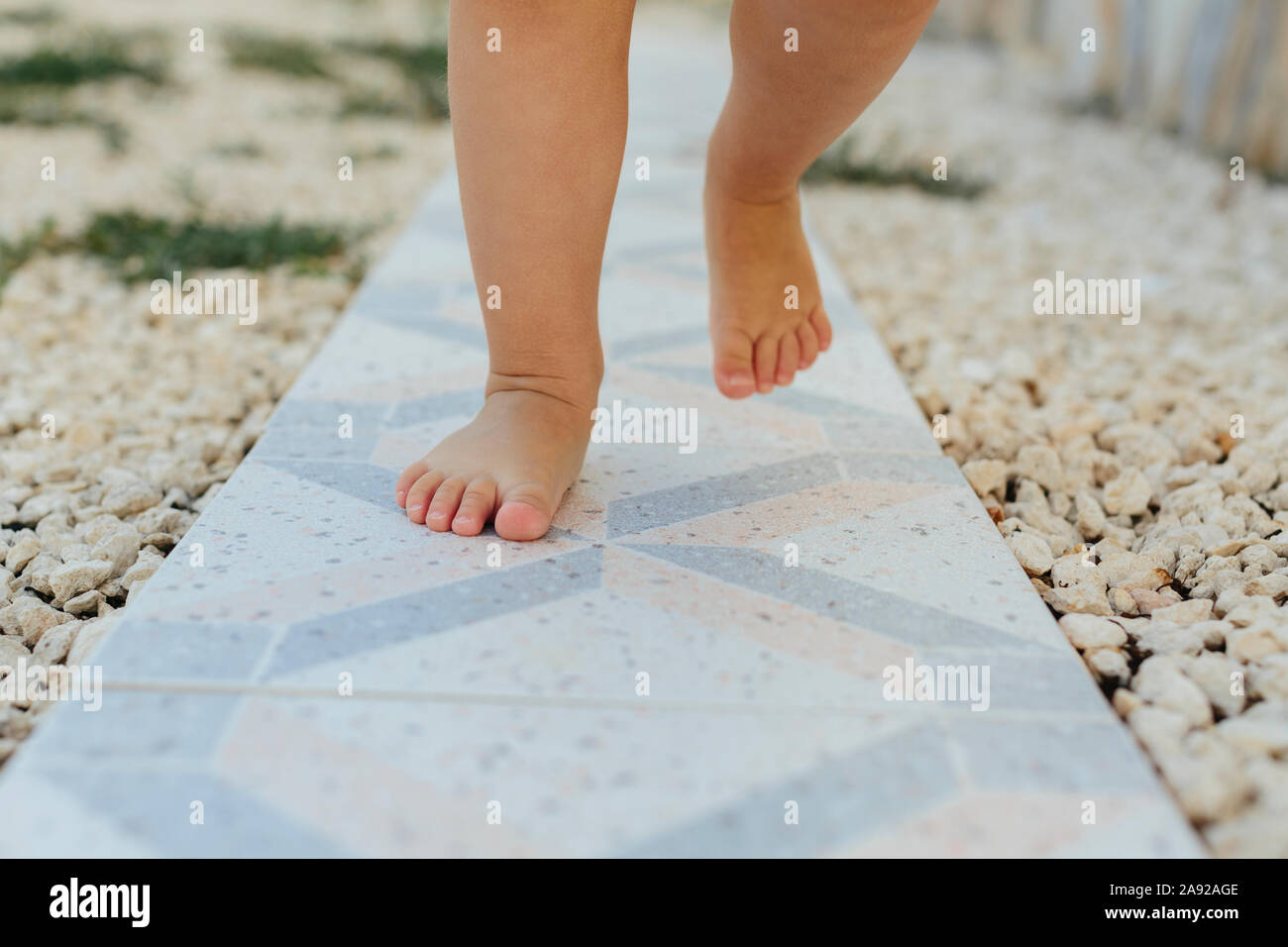 Childs feet on path Stock Photo - Alamy