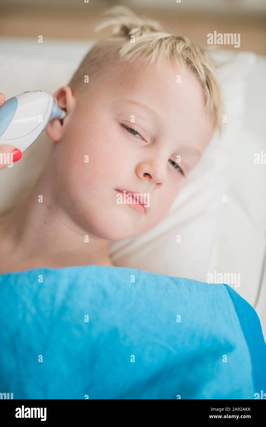 Boy having his temperature taken Stock Photo - Alamy