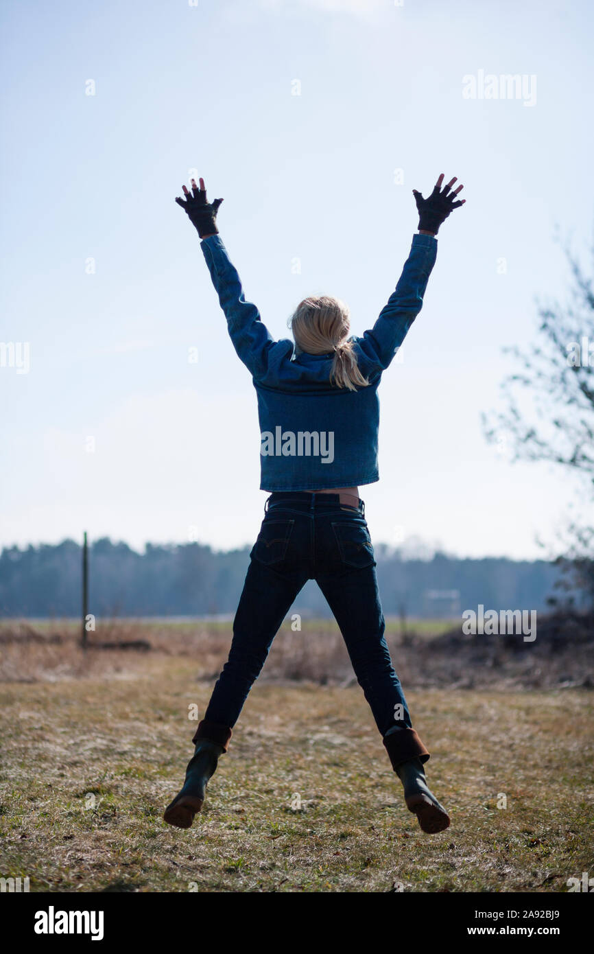 Jumping woman blonde hi-res stock photography and images - Alamy