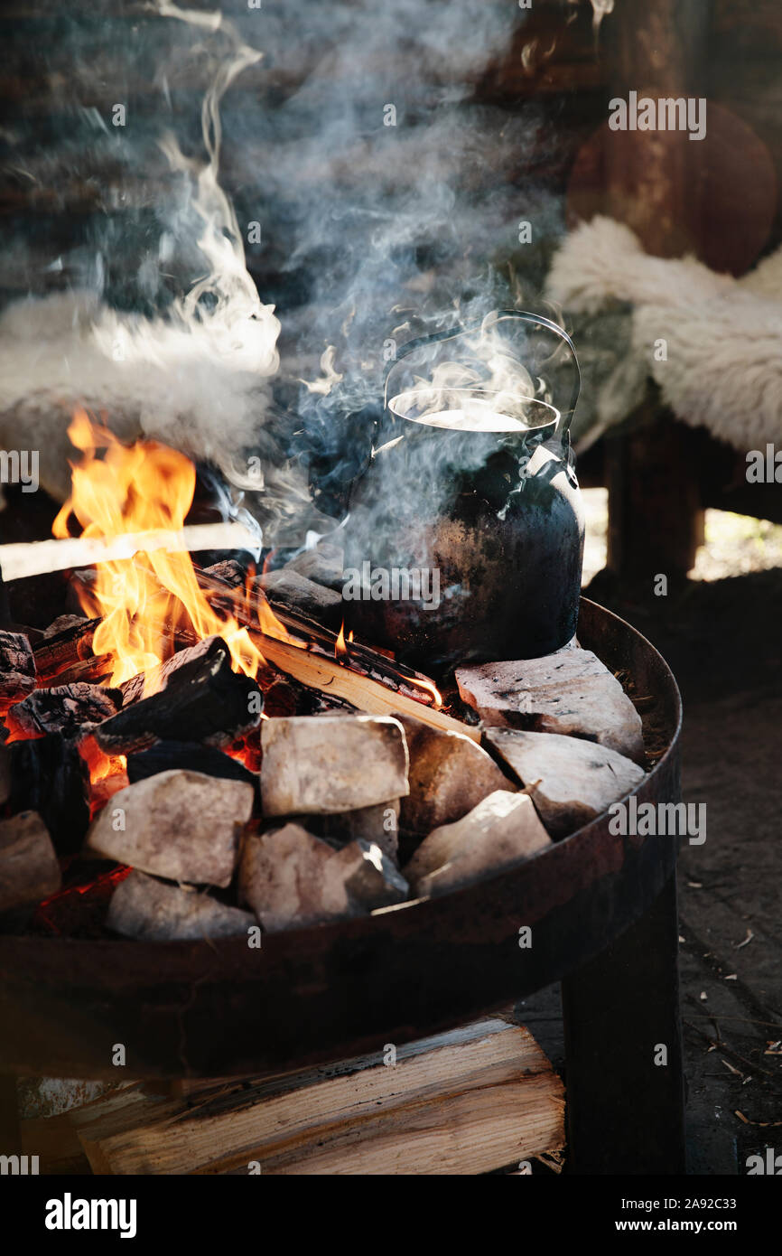 Kettle on log fire Stock Photo - Alamy