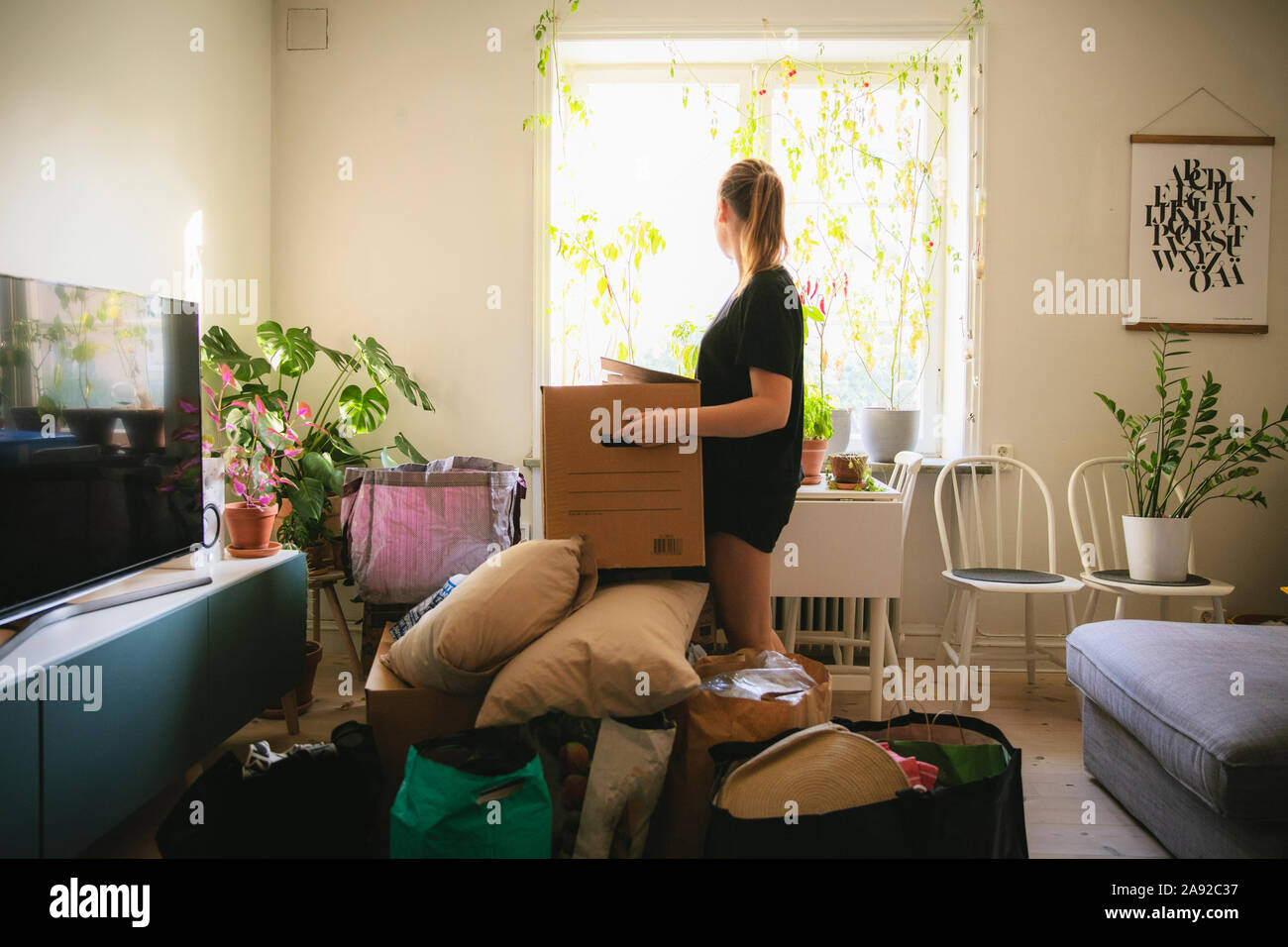 Woman holding box Stock Photo - Alamy
