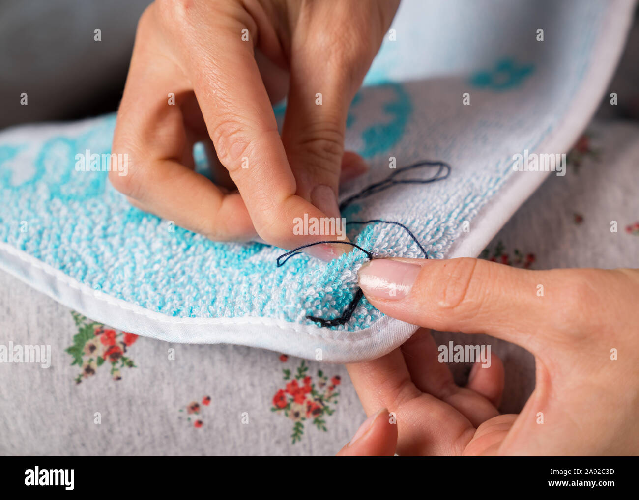 Woman sews up clothes. Hands seamstress close-up. Mending clothes Stock ...