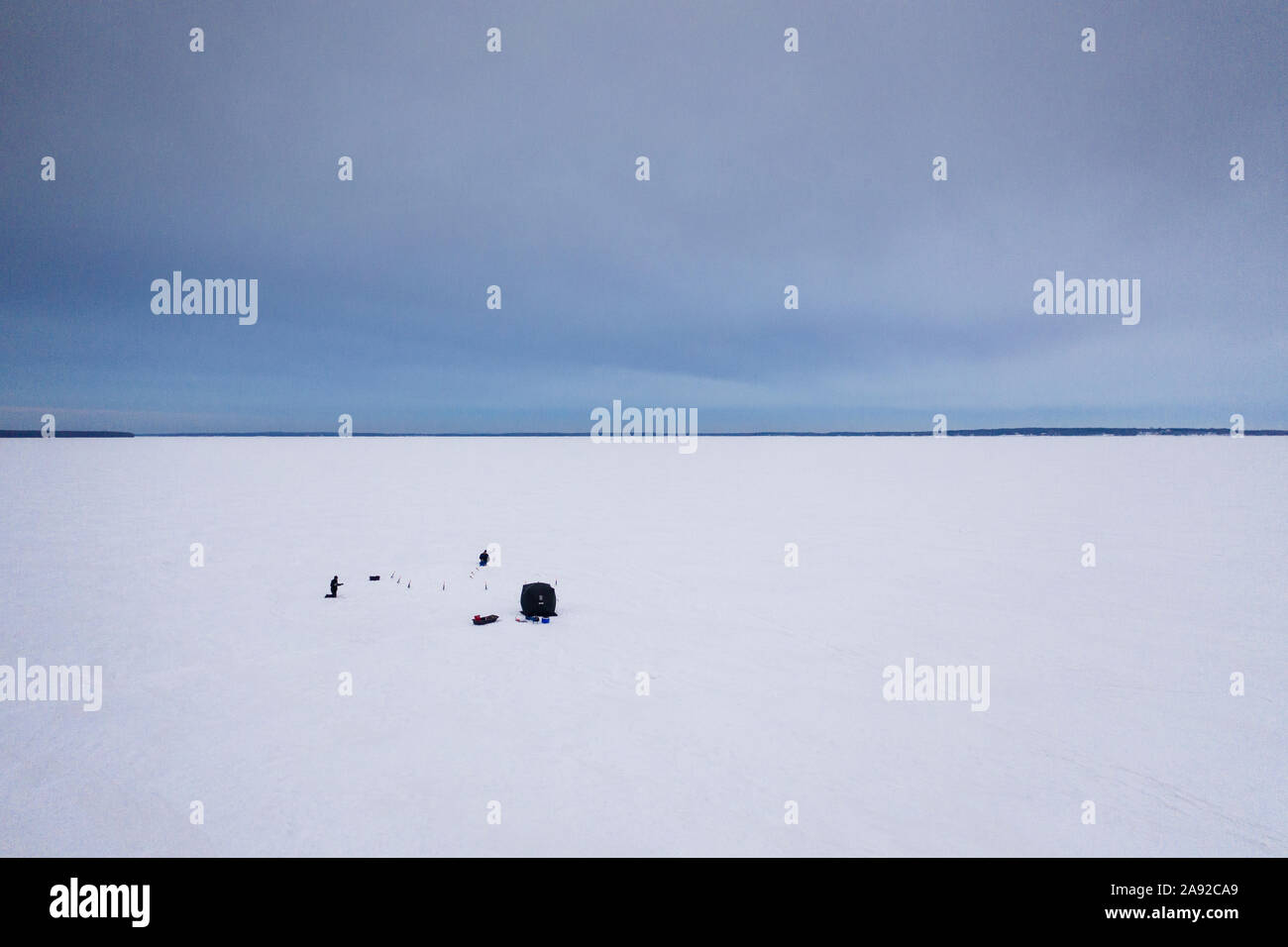 Winter fishing on frozen lake Stock Photo - Alamy