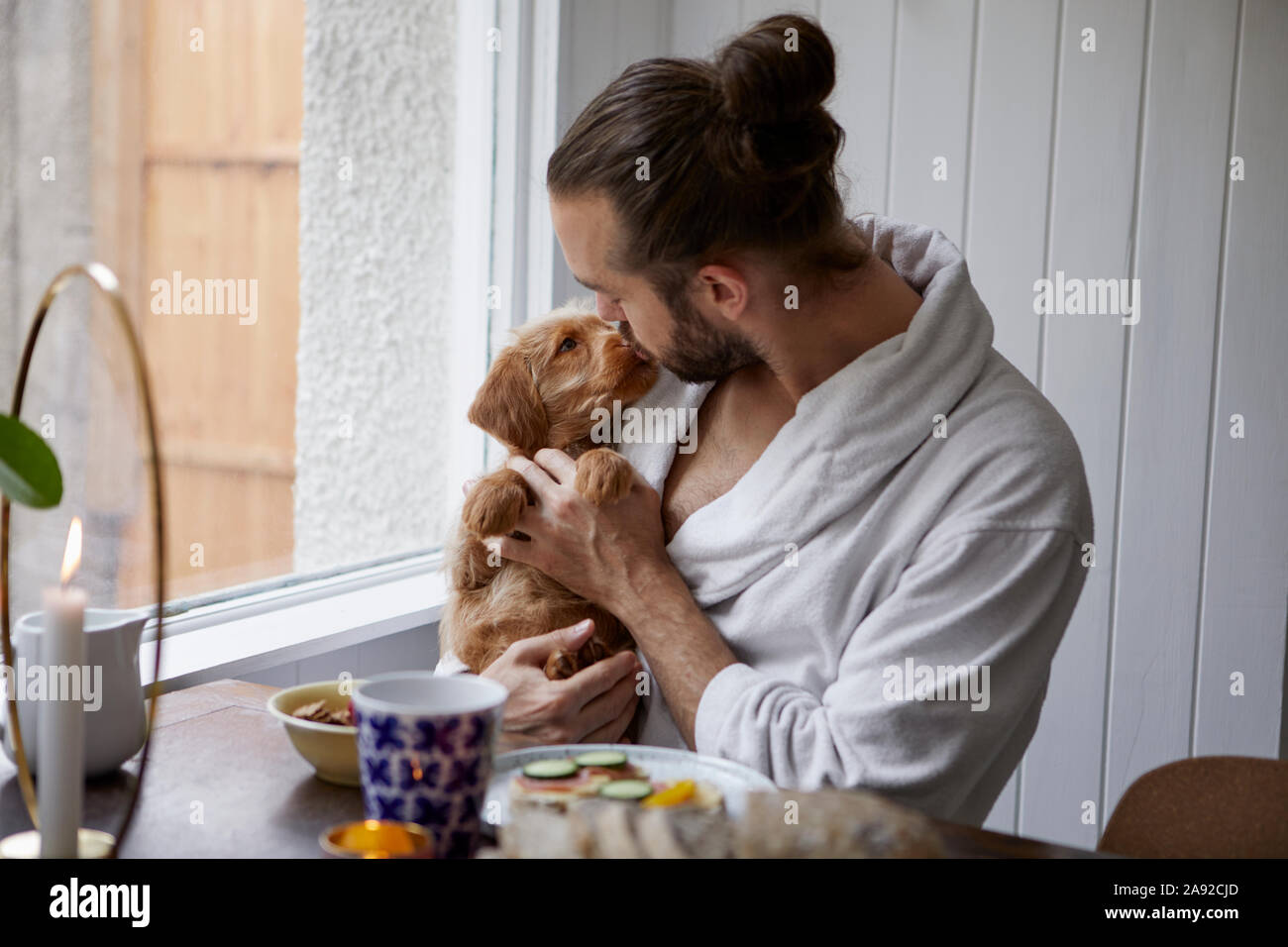 Man holding puppy hi-res stock photography and images - Alamy