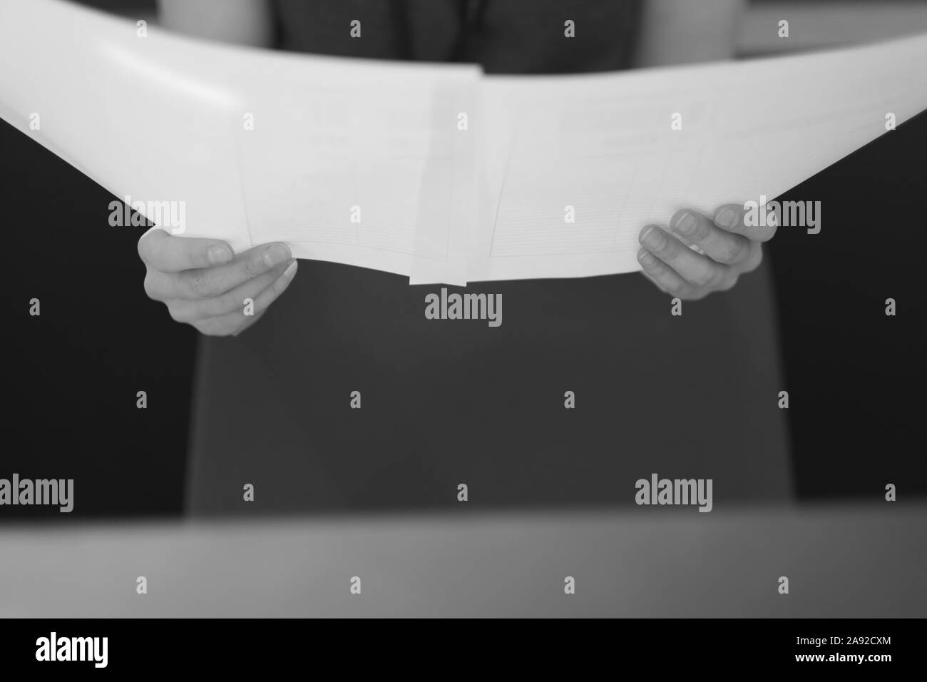 Woman reading a paper document Black and White Stock Photos & Images ...