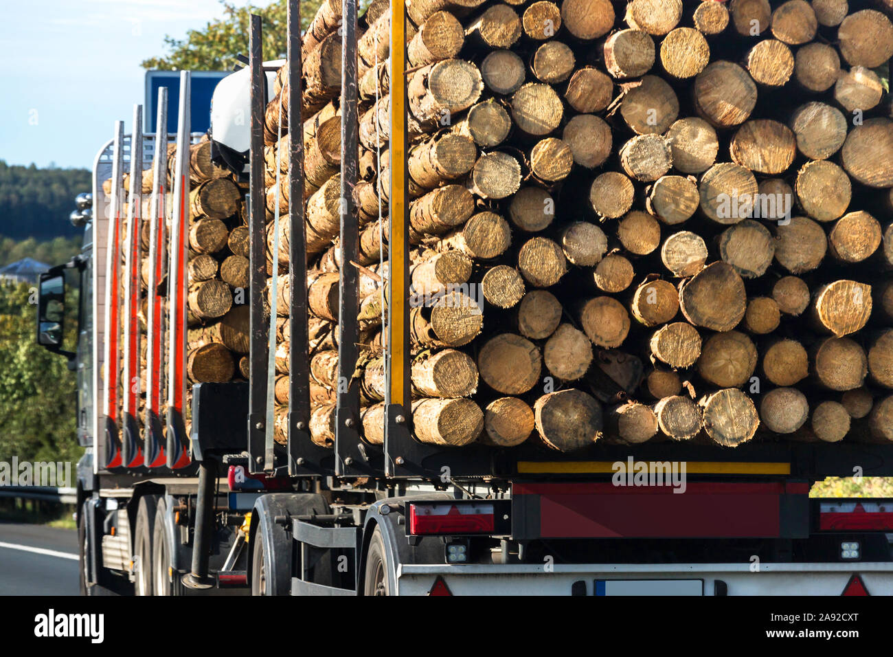 Truck with tree trunks on the highway Stock Photo - Alamy