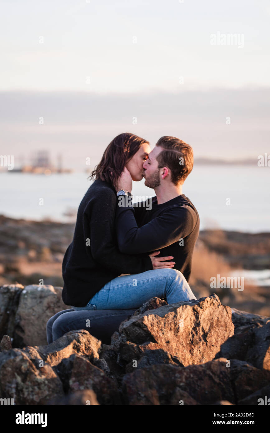 Young couple kissing Stock Photo - Alamy