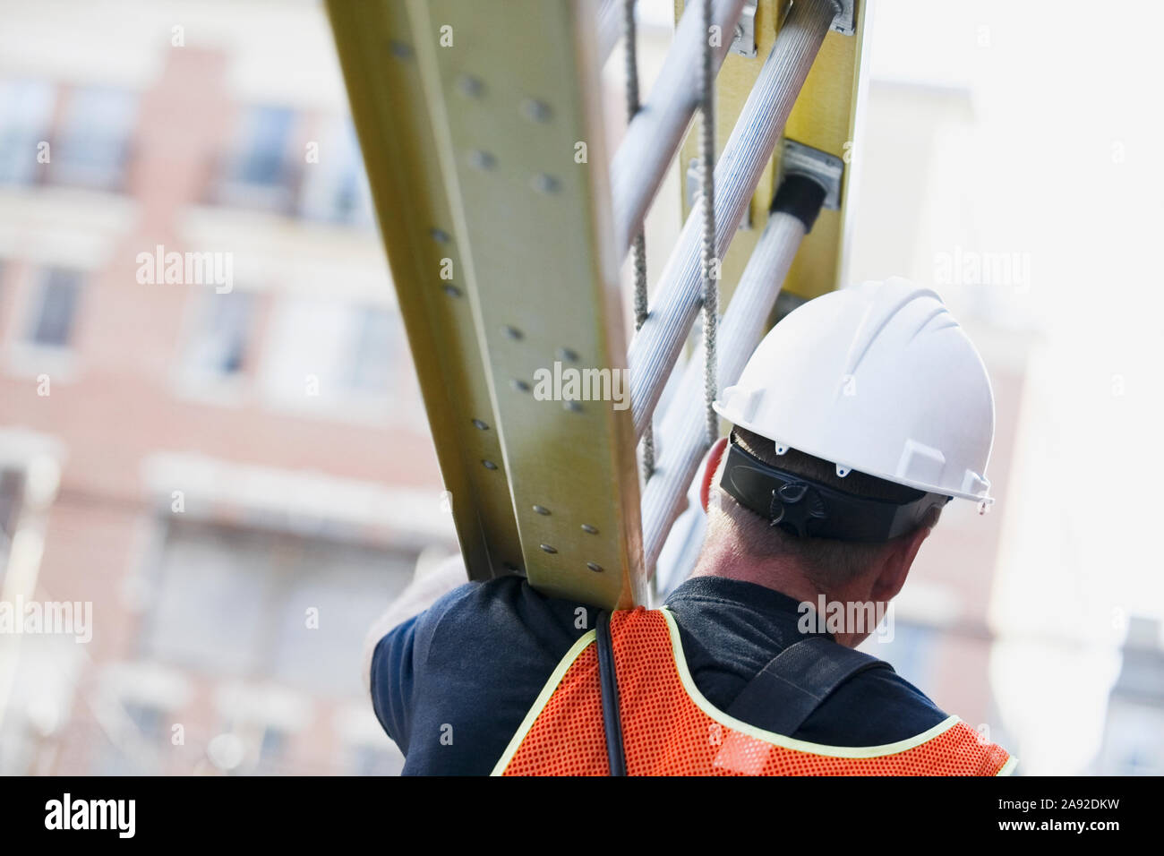 Lineman carrying a ladder Stock Photo - Alamy