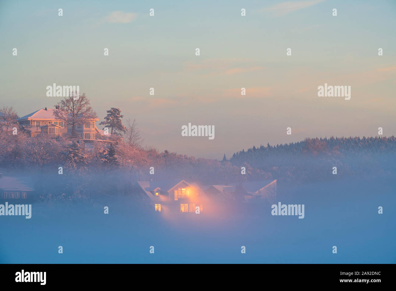 Illuminated house in fog Stock Photo - Alamy