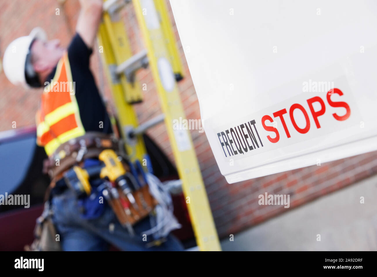 Lineman climbing a ladder Stock Photo - Alamy