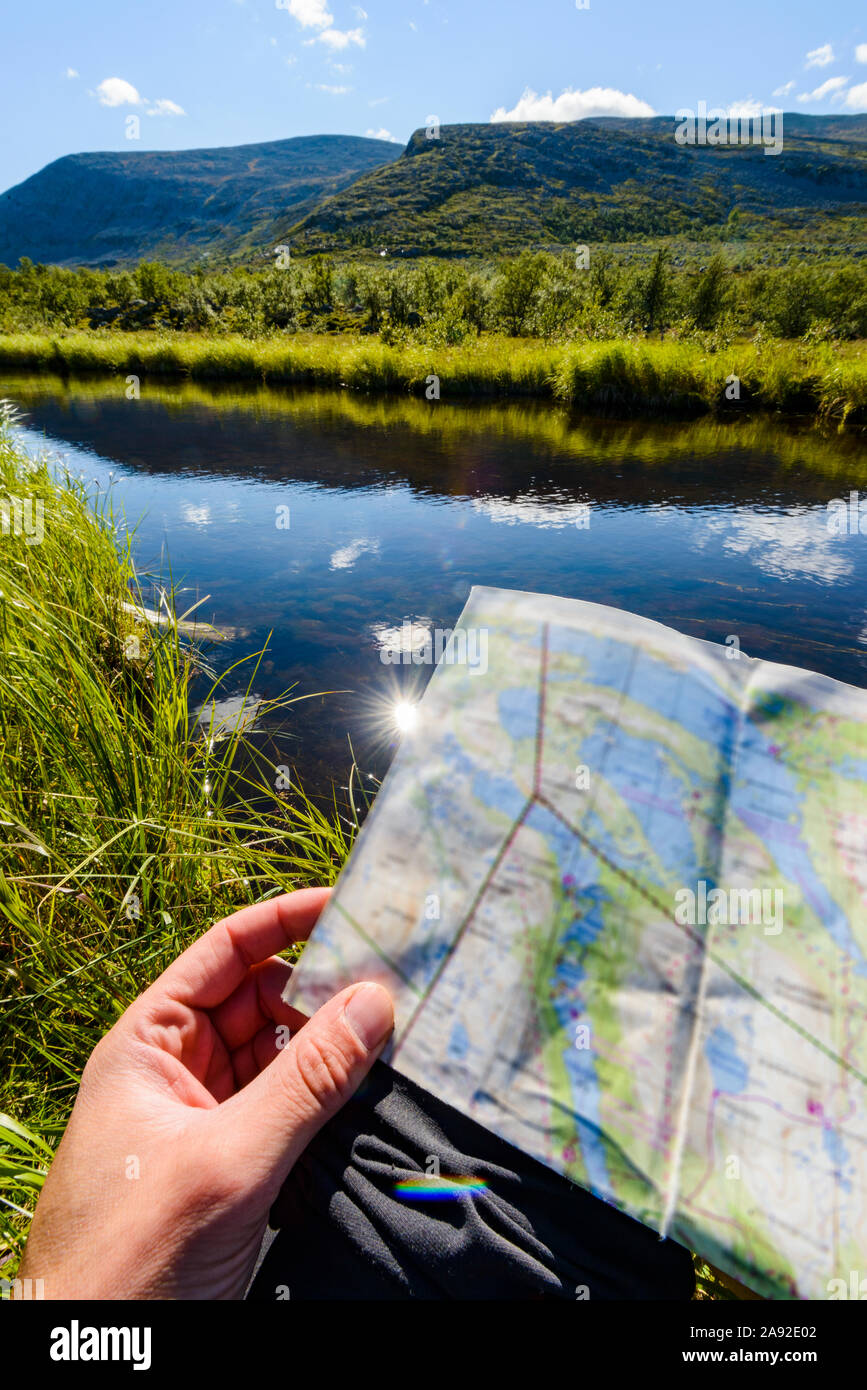 Reading map at lake Stock Photo - Alamy