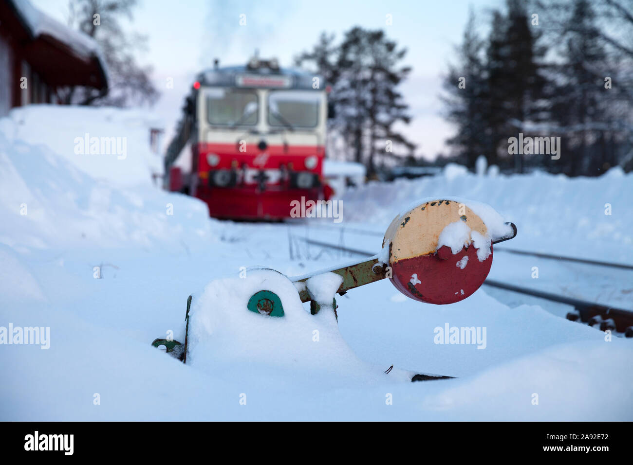 Railroad switch in snow, train on background Stock Photo - Alamy