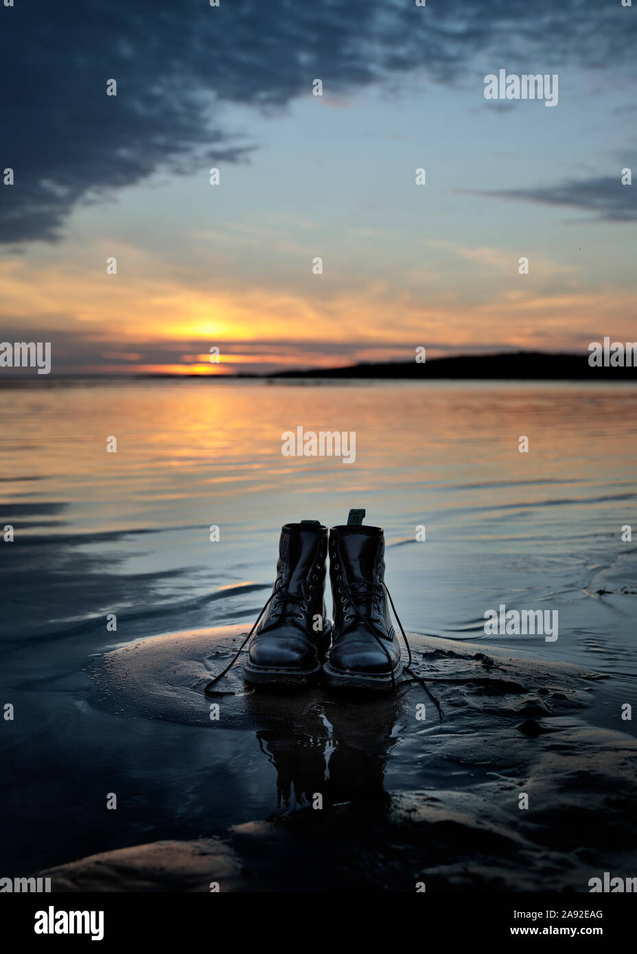 Walking boots at lake Stock Photo - Alamy
