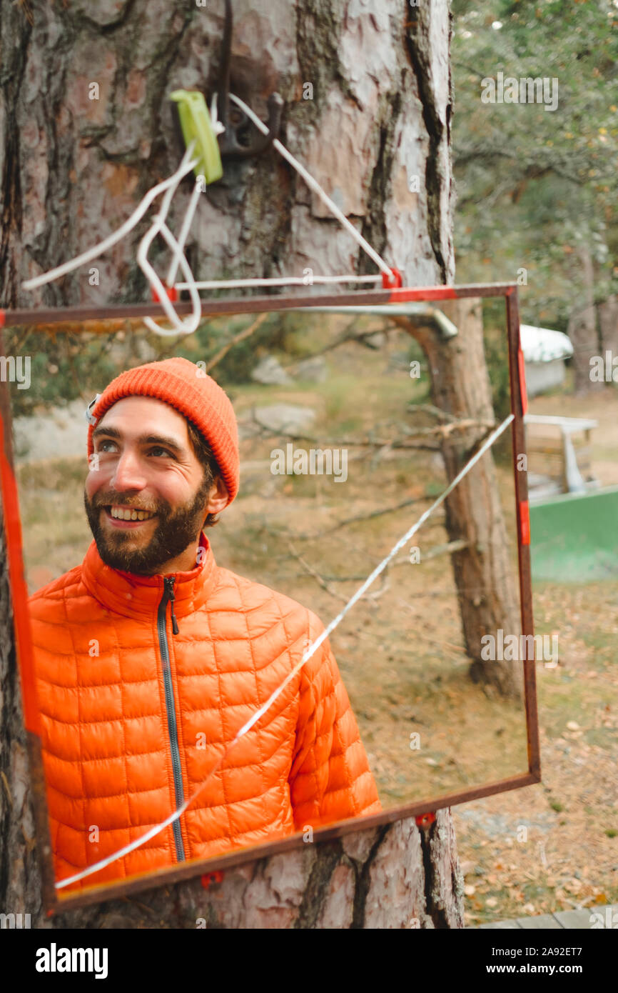 Smiling man reflecting in mirror Stock Photo - Alamy