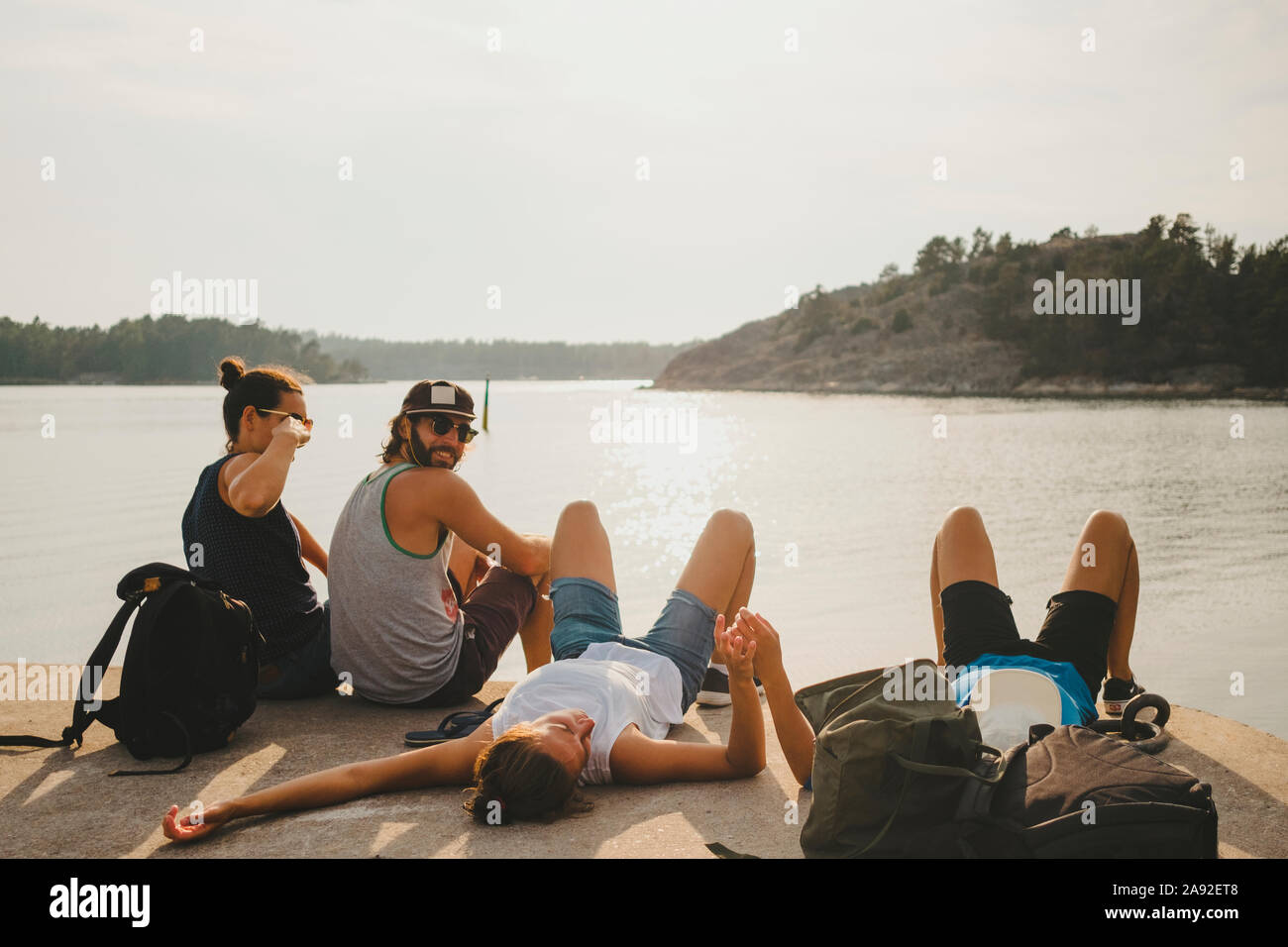Friends relaxing at sea Stock Photo - Alamy